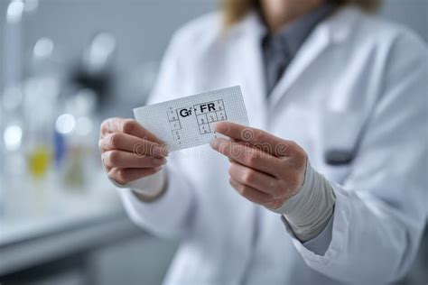 Lab Technician Holds Gfr Test Results In A Modern Laboratory Setting While Examining Patient