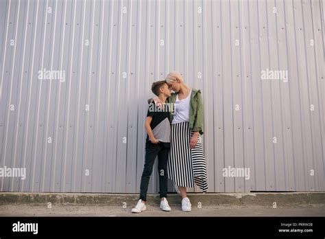 Full Length View Of Mother And Son Touching Foreheads While Standing And Embracing On Street
