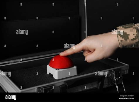 Serviceman Pressing Red Button Of Nuclear Weapon At Black Table Closeup War Concept Stock