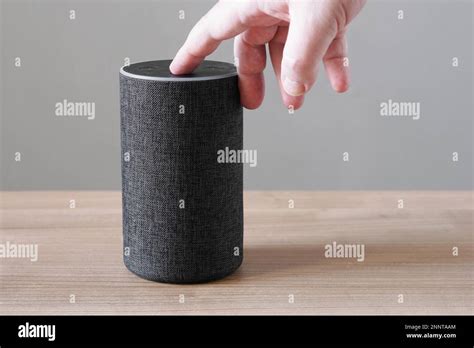 Hand Pushing Button On Smart Speaker Turning Or Switching Off Microphone For Privacy Concerns