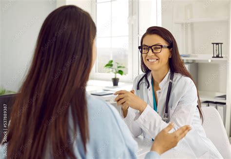 Young Woman Talking To Doctor At Modern Clinic Happy Female Physician