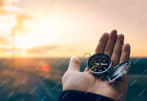 Premium Photo Traveler Explorer Man Holding Compass In A Hand In