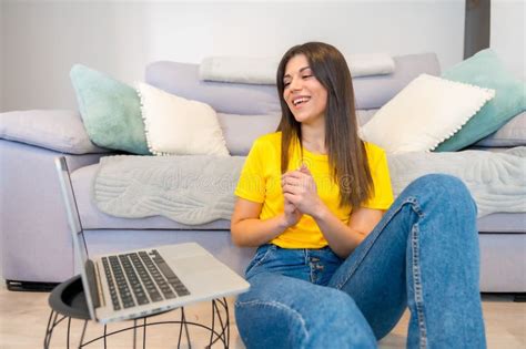 Female Is Sitting On The Floor With A Laptop Computer Resting On Her Lap Stock Image Image Of