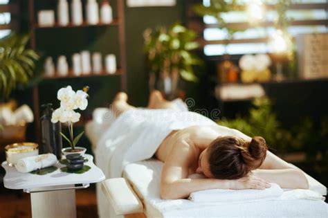 Relaxed 40 Years Old Woman In Spa Salon Laying On Massage Table Stock