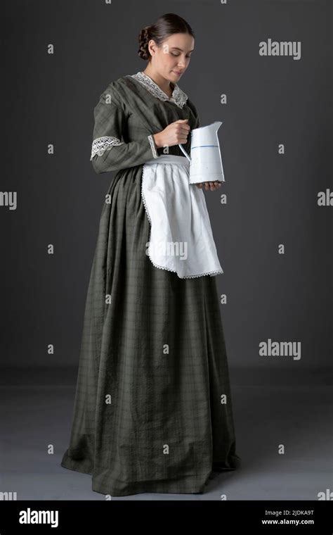 A Victorian Maid Servant Or Working Class Woman Wearing A Dark Green