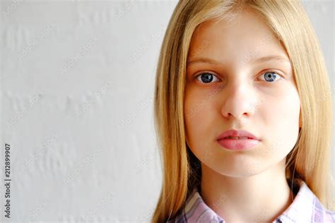 Headshot Of Beautiful Teenage Girl With Blonde Straight Hair Blue Eyes
