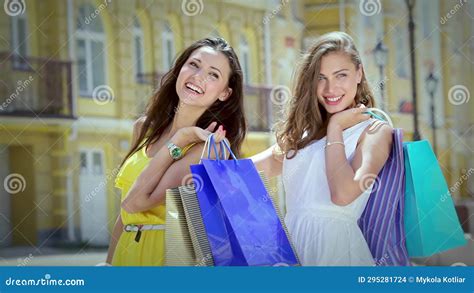 Two Young Pretty Girlfriends With Shopping Bags Posing Stock Footage