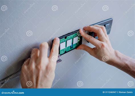 Technician Installing Sensor Light Switch At Modern Villa Stock Image