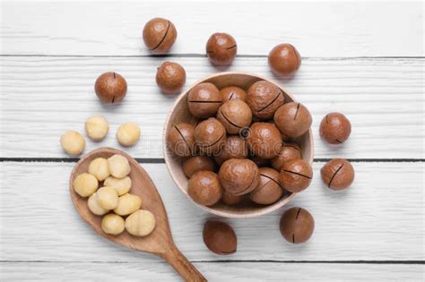 Delicious Organic Macadamia Nuts On White Wooden Table Flat Lay Stock