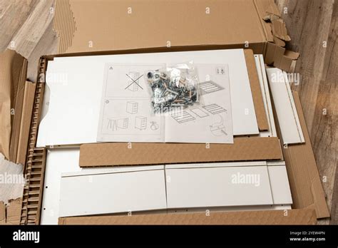 A Box Of Screws And A Bag Of Screws Lie On The Box With Furniture And