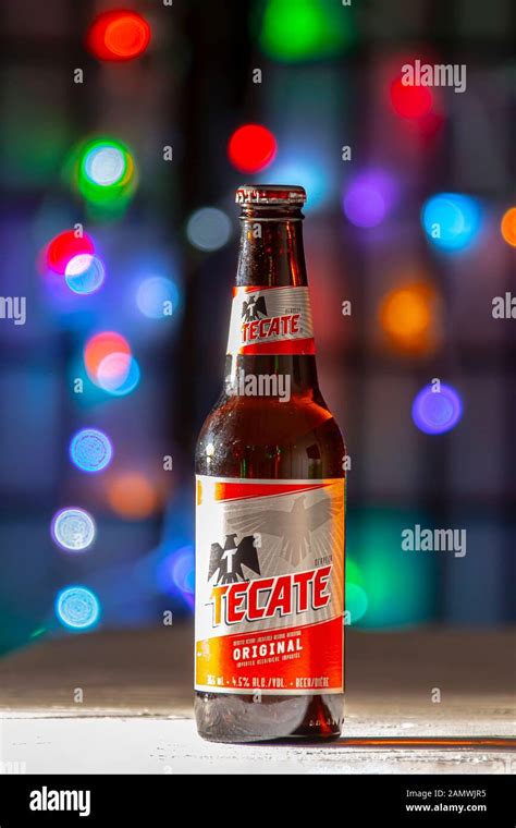 A Bottle Of Tecate Beer A Mexican Beer On A White Texture Surface On A