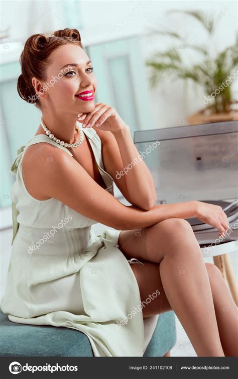Attractive Pin Girl Talking Vintage Yellow Phone While Fixing Stockings