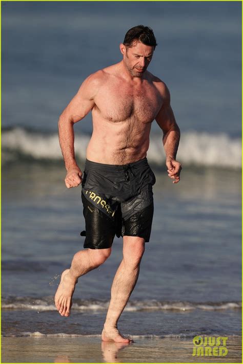 Hugh Jackman Runs Shirtless On The Beach With His Ripped Muscles On