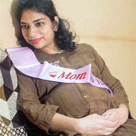 A Pregnant Indian Lady Poses For Indoor Pregnancy Shoot And Hands On