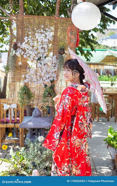 The Girl Is Wearing A Red Traditional Kimono Which Is The National