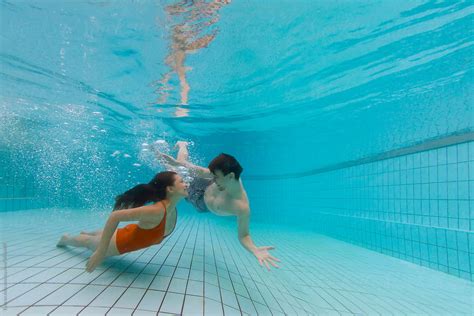A Couple Side By Side Underwater In A Pool By Stocksy Contributor