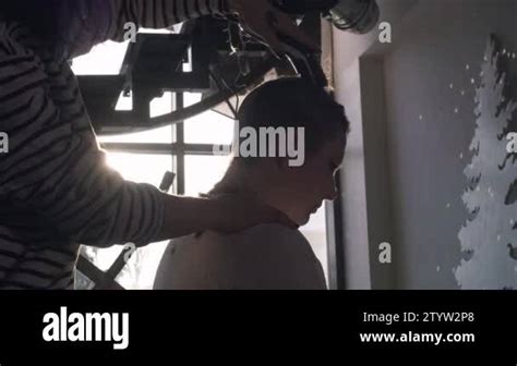 Young Attractive Girl Shaves Her Hair On Her Head Shaves His Head With An Electric Razor Or