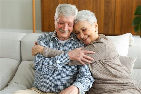 Senior Adult Mature Couple Hugging At Home Mid Age Old Husband And Wife Embracing With
