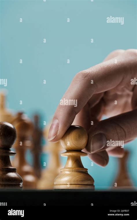 professional player moving a pawn on the chessboard chess game and