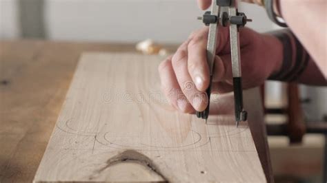 A Carpenter Marks A Pine Wooden Plank With A Compass Woodworker Using