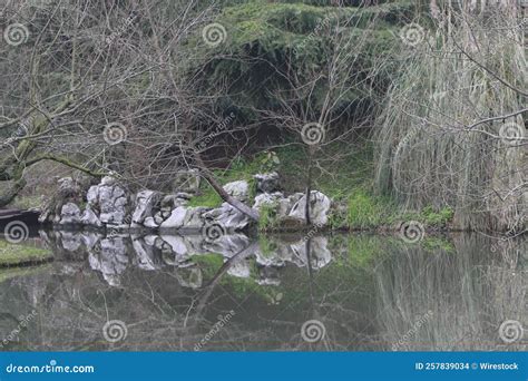 Small Pond In A Park With Stones On The Shore In Hangzhou China Stock