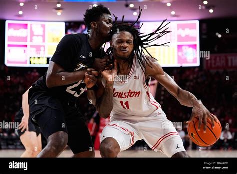 Towson Forward Caleb Embeya 23 Defends Against Houston Forward Joseph Tugler 11 During The
