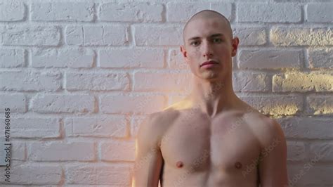 Young Bald Shirtless Handsome Homosexual Man Posing Over The White Wall