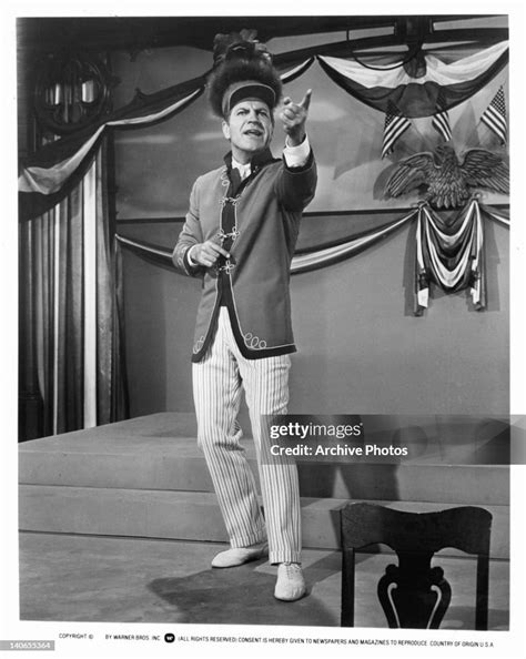 Robert Preston As Harold Hill Gestures While Standing Alone In A