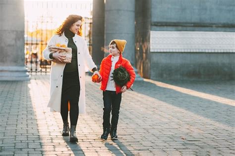 Premium Photo A Beautiful Mother With Her Son In A Bright Orange