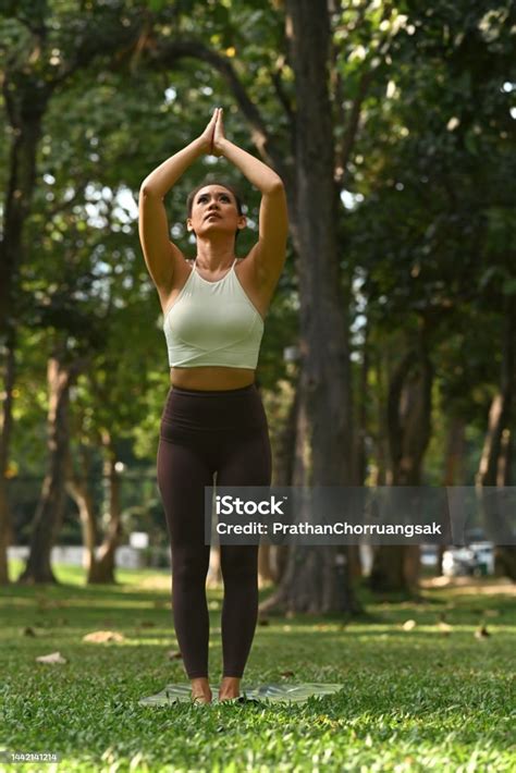 Full Length Portrait Of Sporty Woman Practicing Yoga Standing In