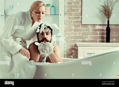 Happy Young Couple In Bathroom At Home Showering Person At Home