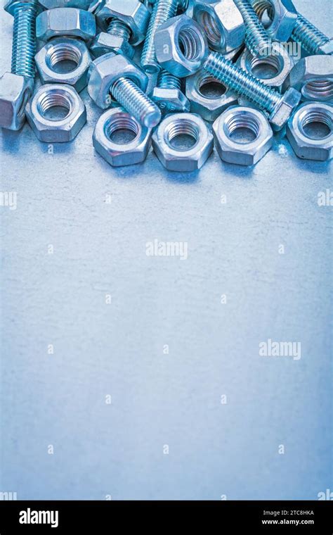 Copy Space Vertical Image Of Metal Bolts And Nuts On Metallic