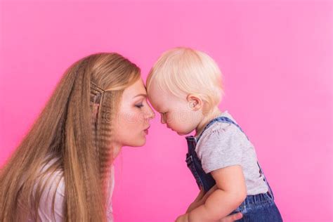 Jonge Moeder En Dochter Die Pret Samen Op Roze Achtergrond Hebben Stock