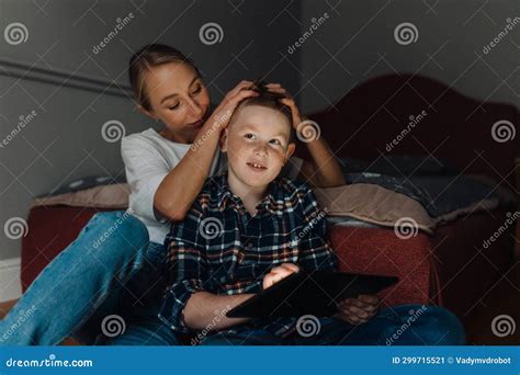 Mom Touching Her Son S Head While Using Digital Tablet At Home Stock