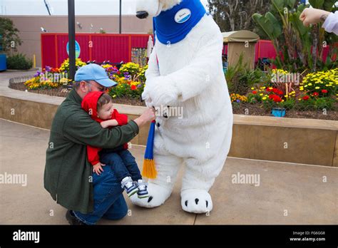 Tourists Pose For A Picture With A Big Polar Bear Mascot At Sea World