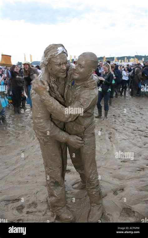 Mud Monsters Two Excited Young Men Wrestling In The Mud At The