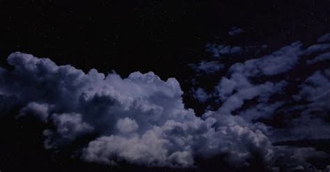 Time Lapse Off A Night Sky With Clouds Moving Fast Before The Night Sky