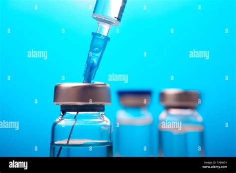 Vaccines And Flu Shot Drug Needle Syringe On Blue Background Stock