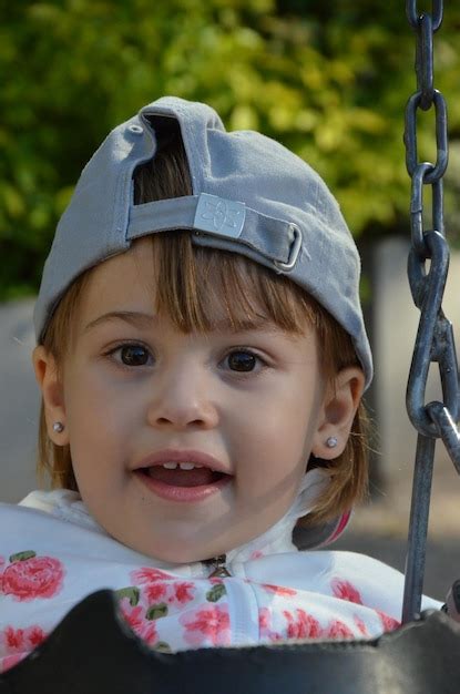 Premium Photo Little Blonde Girl On The Swing