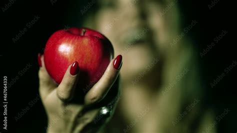 Woman As Witch With An Evil Grin Laugh In Black Offers Red Apple As