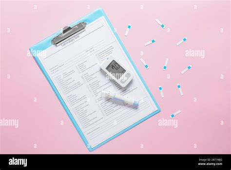 Laboratory Test Glucometer And Lancet Pen On Color Background