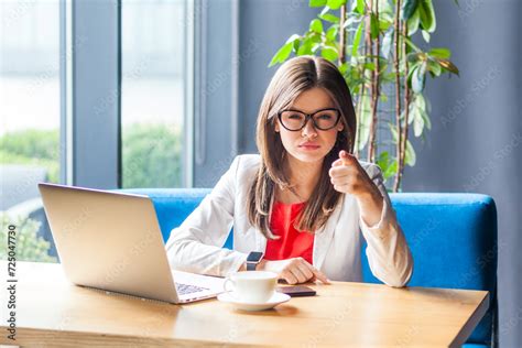 Portrait Of Strict Bossy Woman Working On Laptop Looking At Camera
