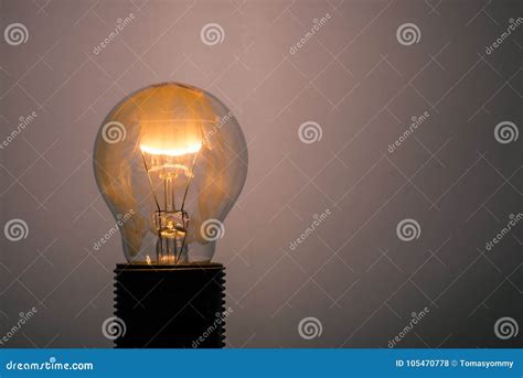 Single Glass Bulb Mounted In Socket With Flame And Smoke Inside Stock