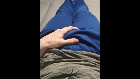 A Guy In Blue Sweatpants Rubs His Bulge