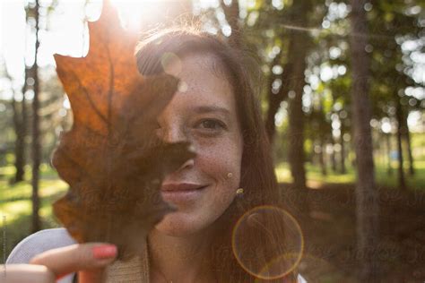 Portrait Of A Cute Girl Holding A Leaf In Front Of Her Face By