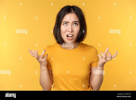Image Of Angry Asian Woman Shouting And Cursing Looking Outraged