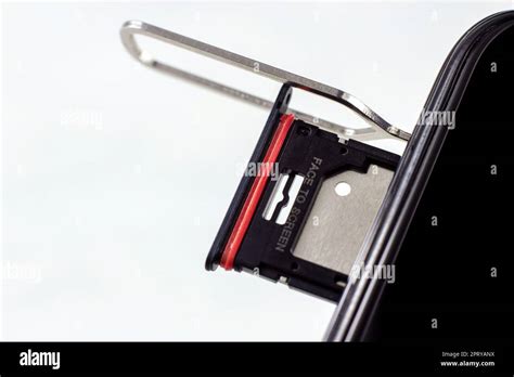 Pulling Out The Phone Sim Card Tray From The Smartphone With The Help Of Edgector Close Up Stock