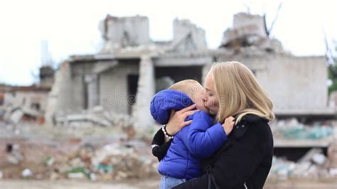 Mother With Her Son Who Is Crying Near The Destroyed House Stock Video