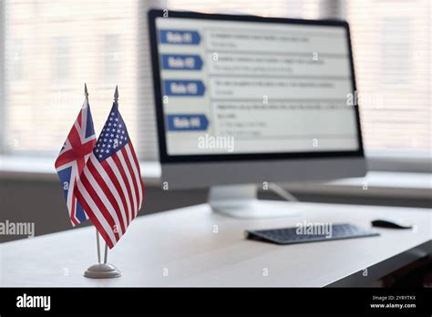 Close Up On Small National Flags Of Usa And Great Britain Standing On