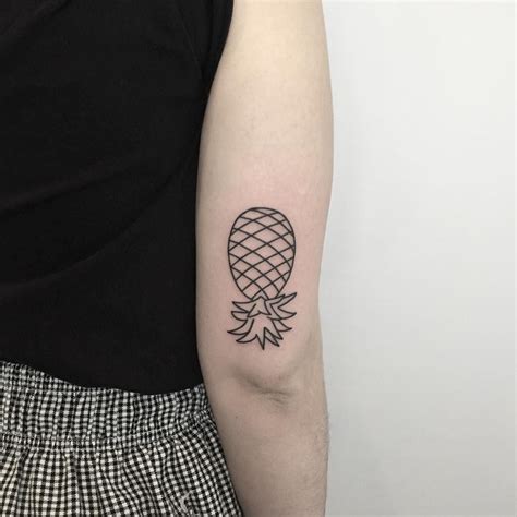 Upside Down Linear Pineapple Tattoo Inked On The Back Of The Right